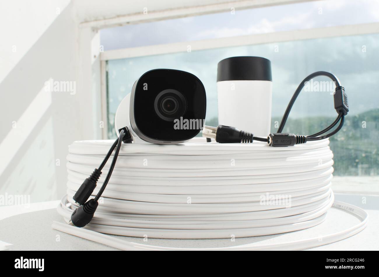 Close-up of a security camera with a coil of wire, reinforcing the ...