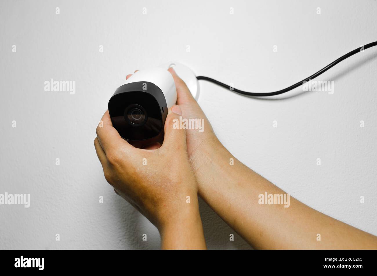 Skillful hands taking care of the maintenance of a white security ...