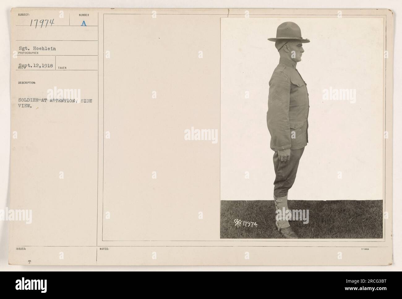 Soldier at attention, captured in a side view. The photograph was taken ...