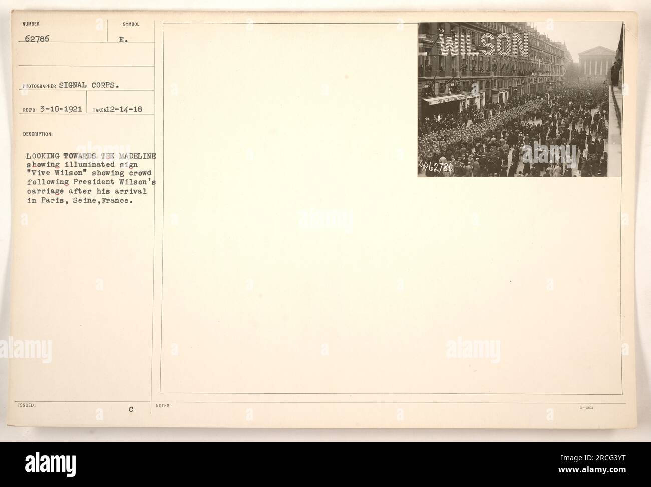 Caption: "Crowd following President Wilson's carriage after his arrival ...