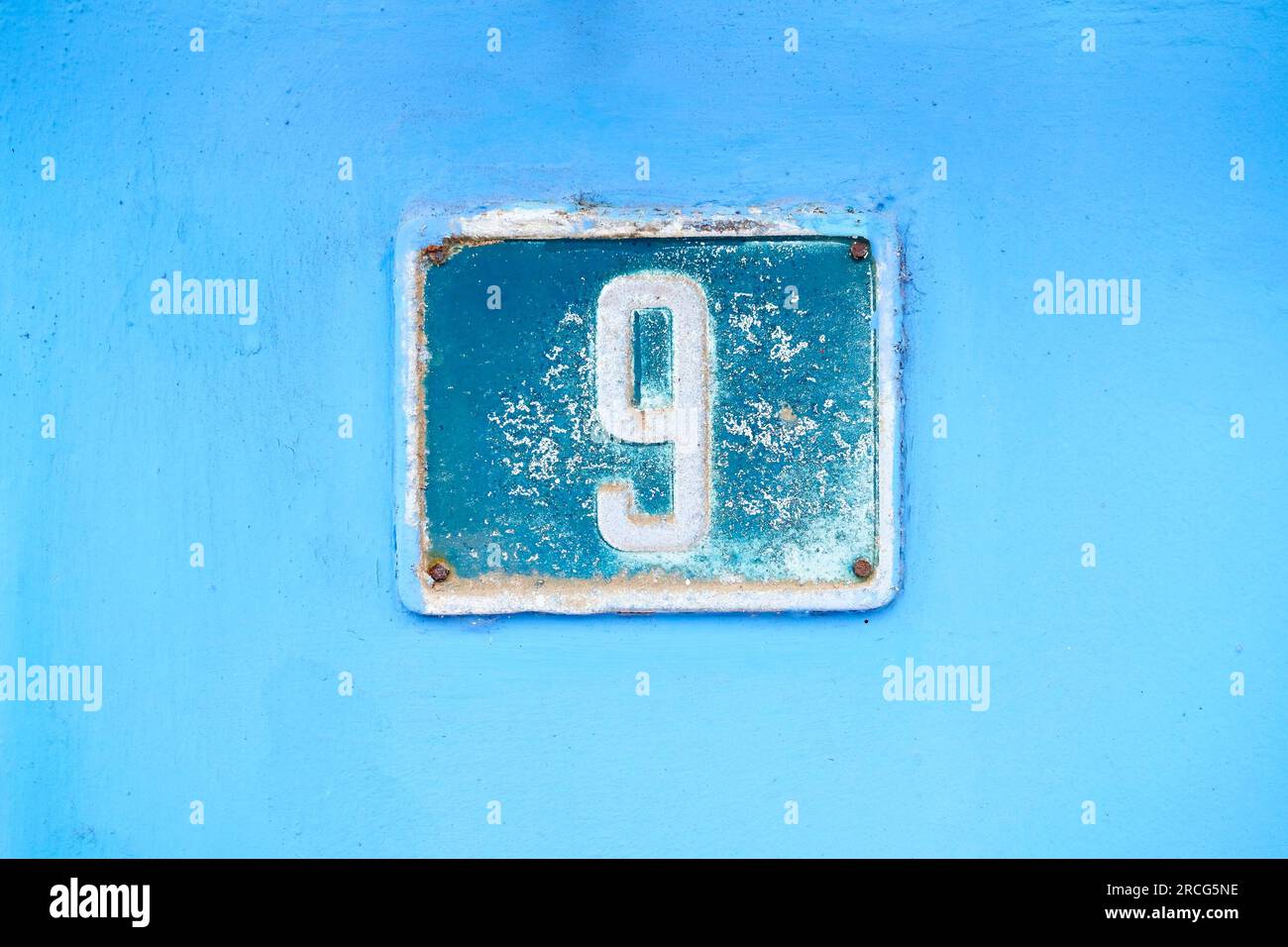 Number 9, digit nine, dark blue plate on light blue background Stock ...