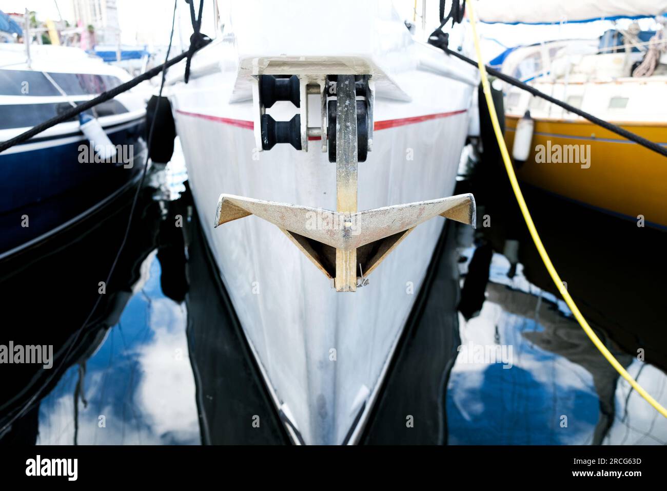 Bow section of a modern sailing yacht with anchor on anchor roller ...
