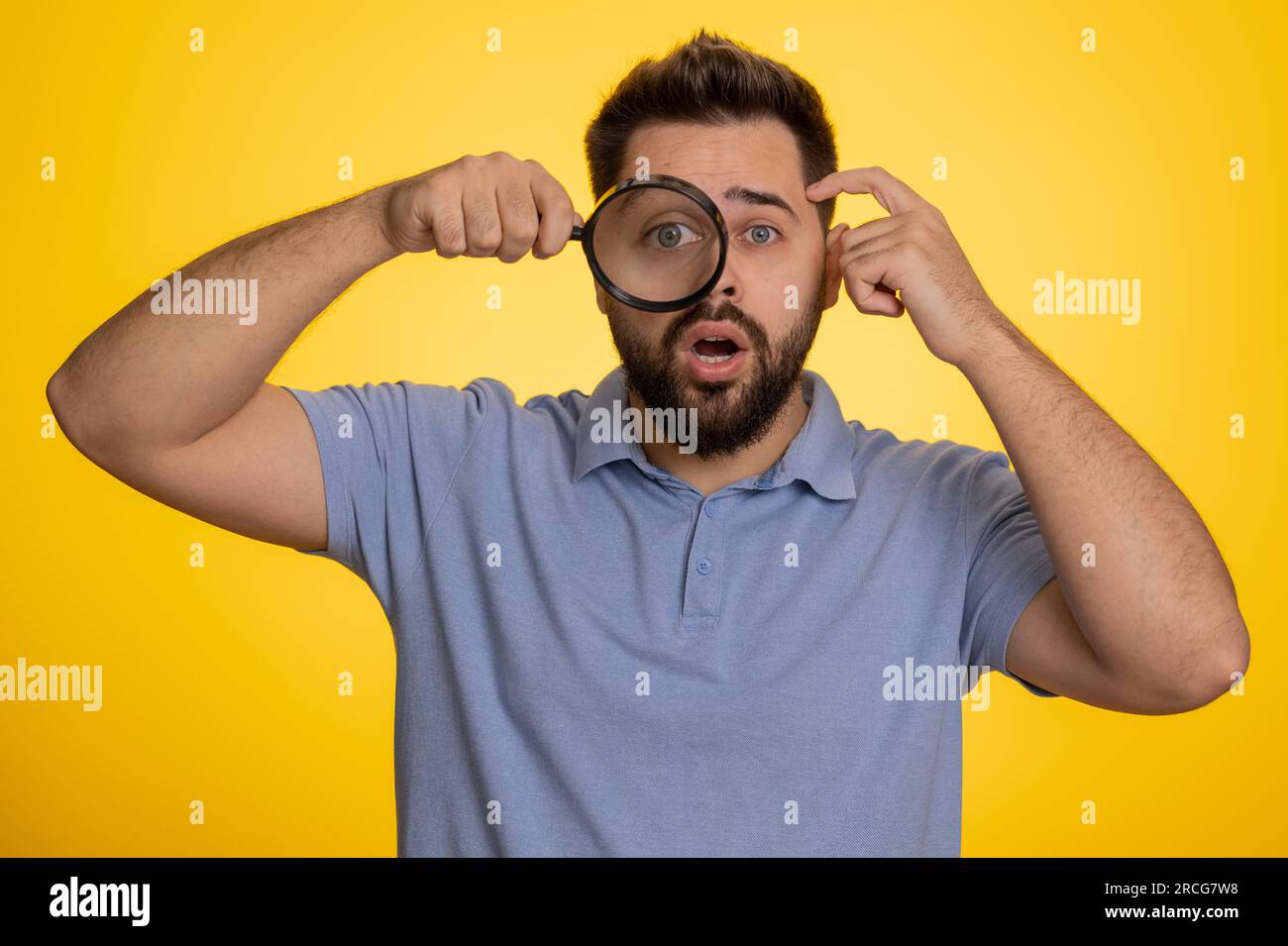 Investigator Researcher Scientist Man Holding Magnifying Glass Near Face Looking Into Camera
