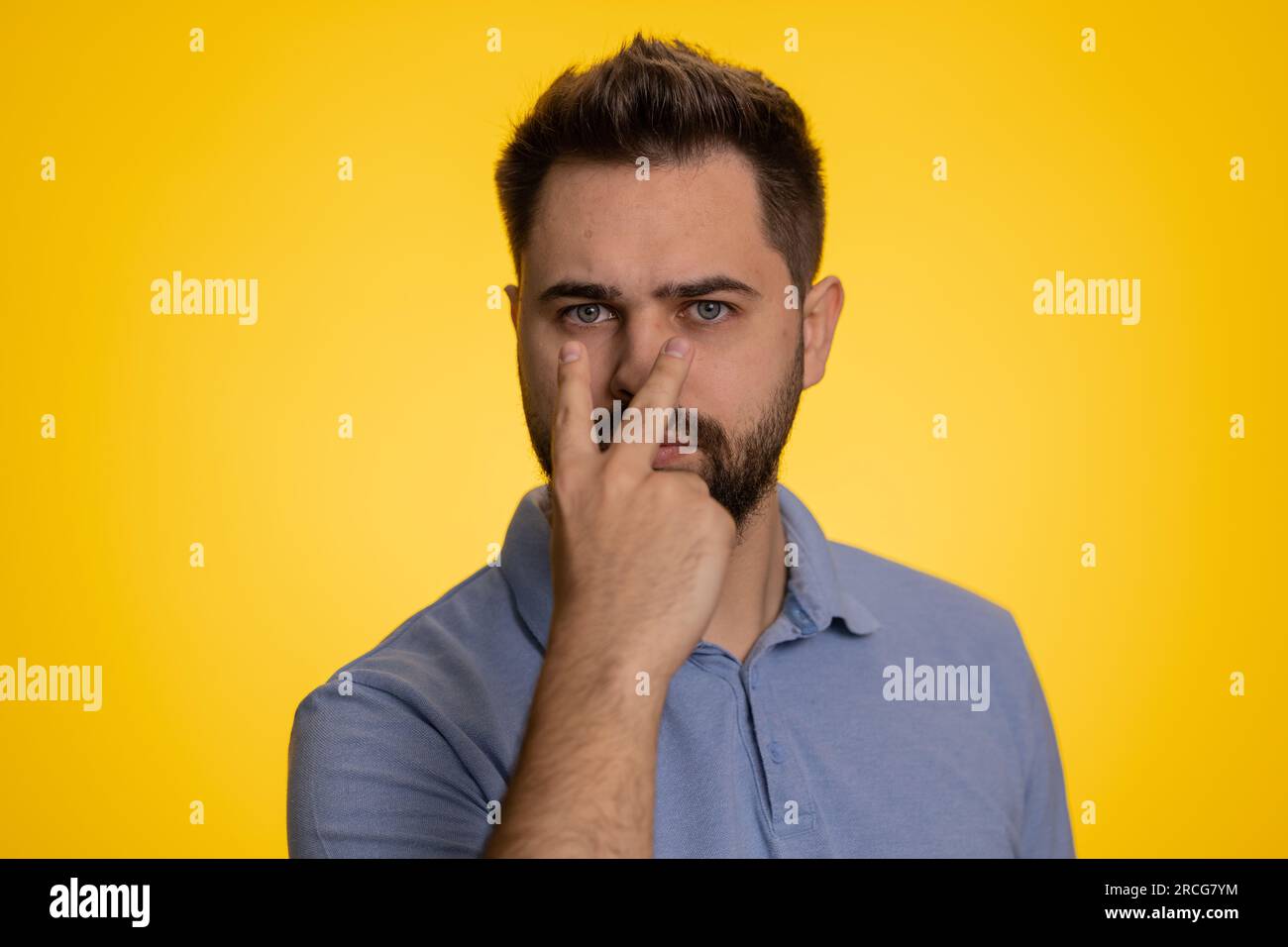 I am watching you. Young confident caucasian man pointing at his eyes ...