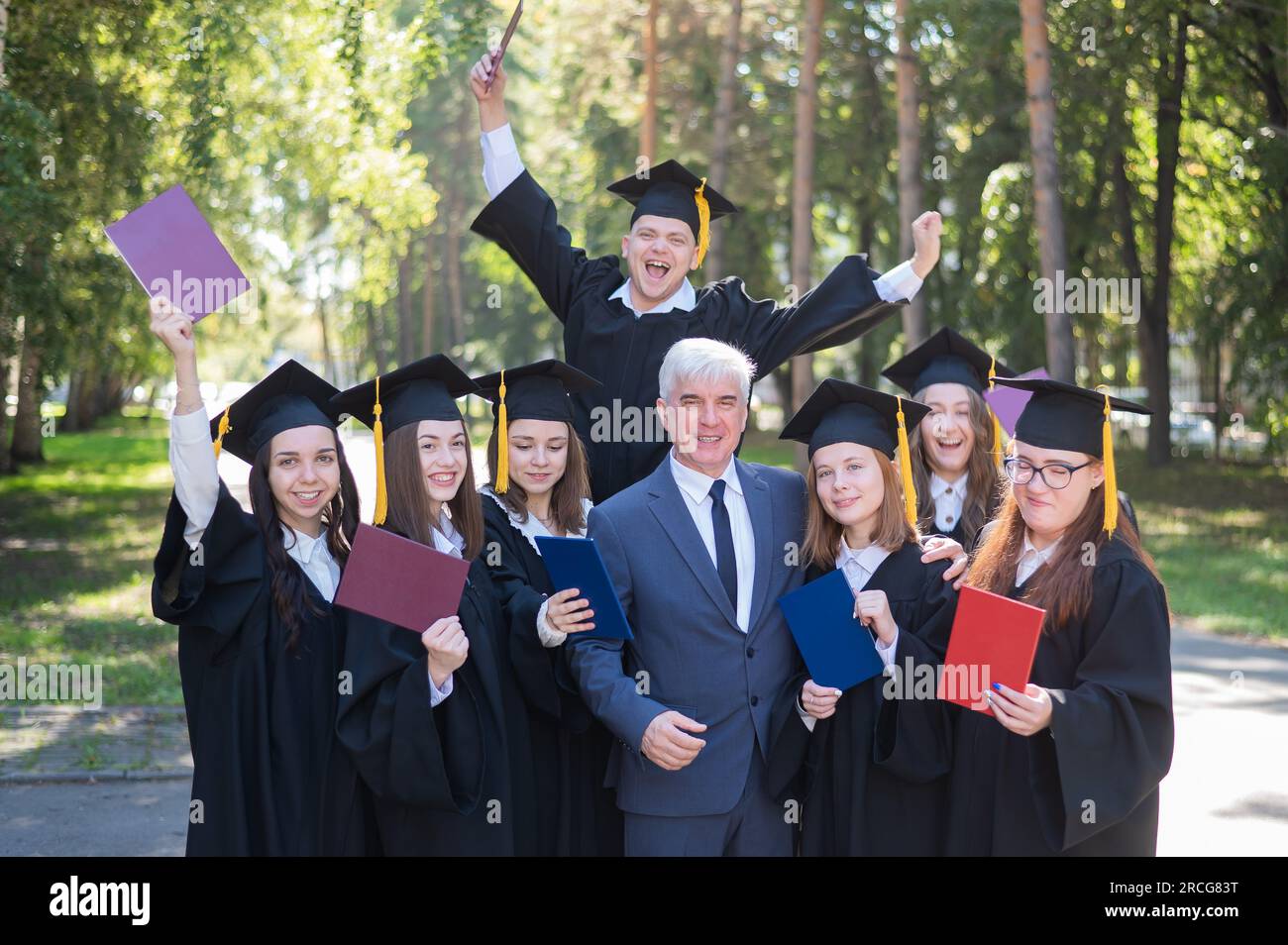 University professor and seven graduates rejoice at graduation Stock ...