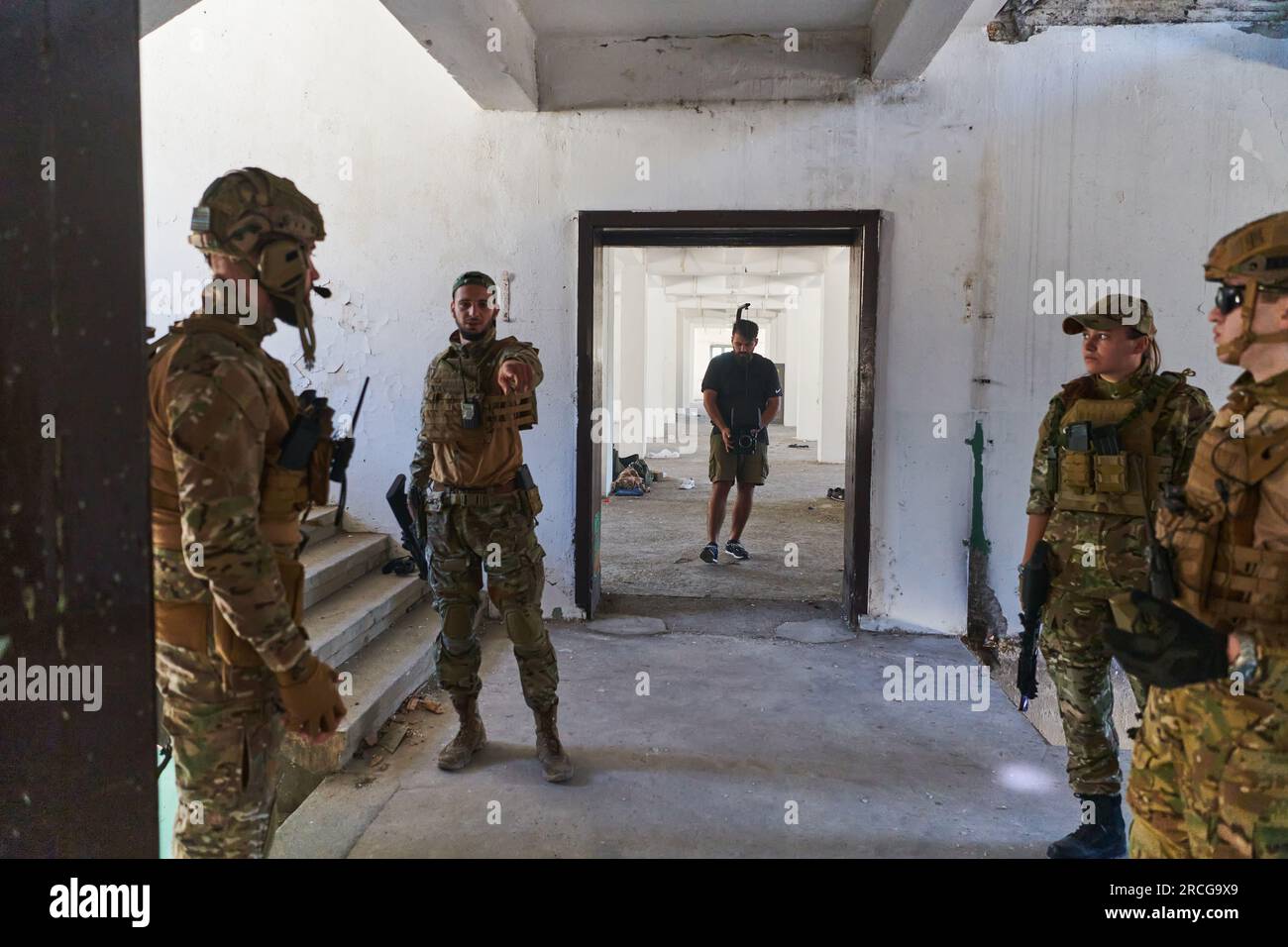 Group of soldiers discusses military tactics while situated in an ...