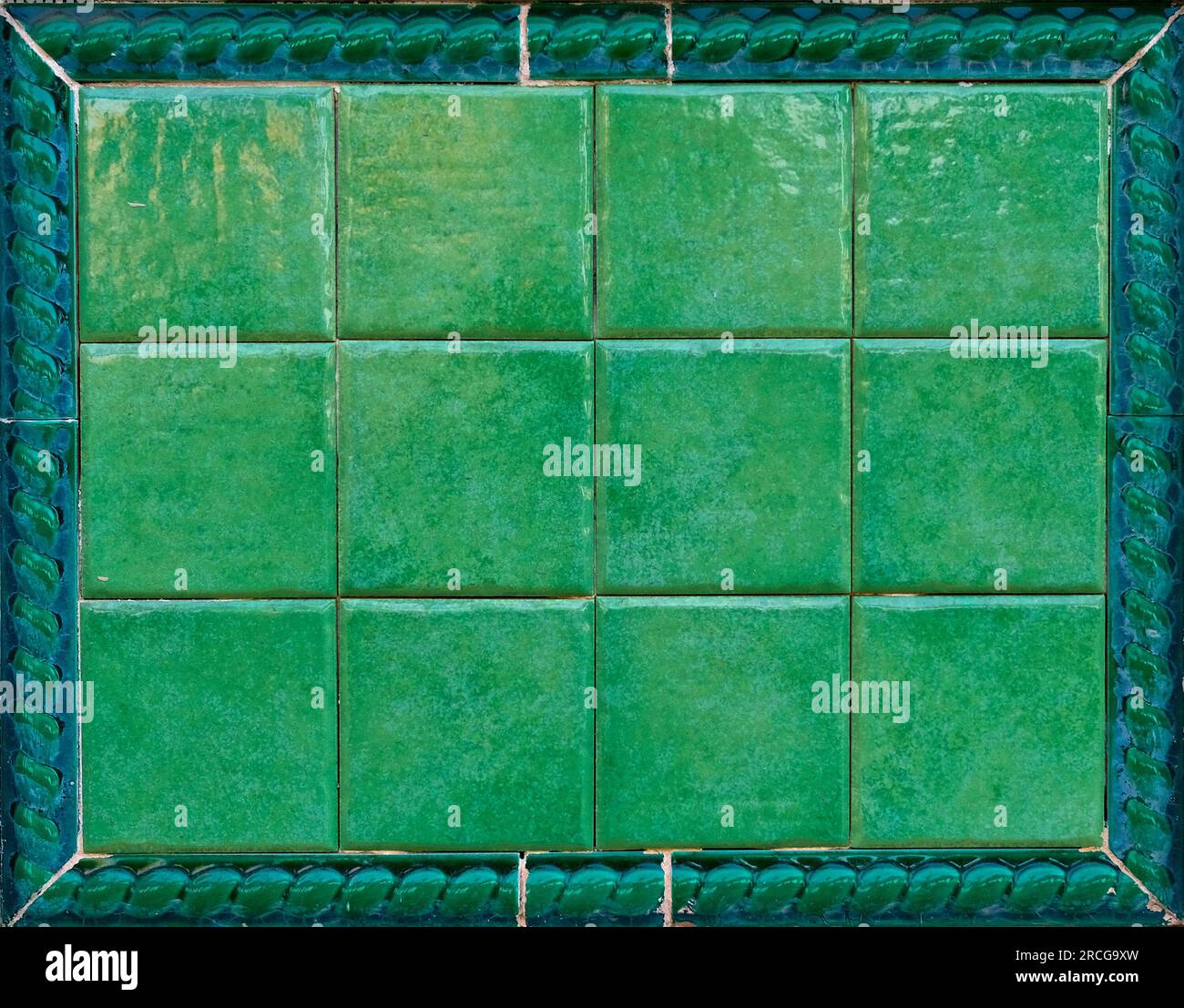 3x4 green glazed glossy tiles with floral dark frame, empty surface for ...
