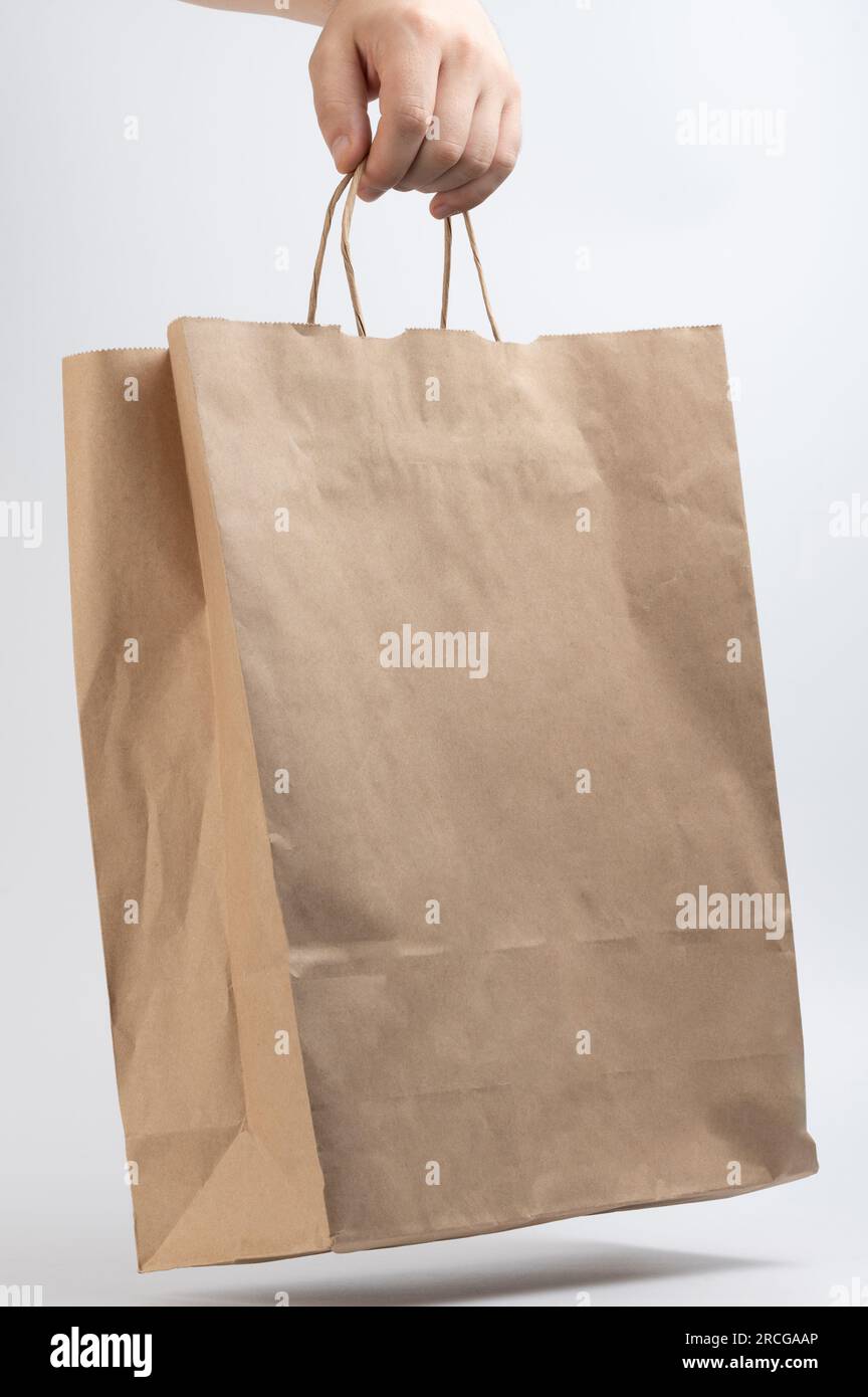 Hand carry recycled paper bag isolated on white studio background Stock ...