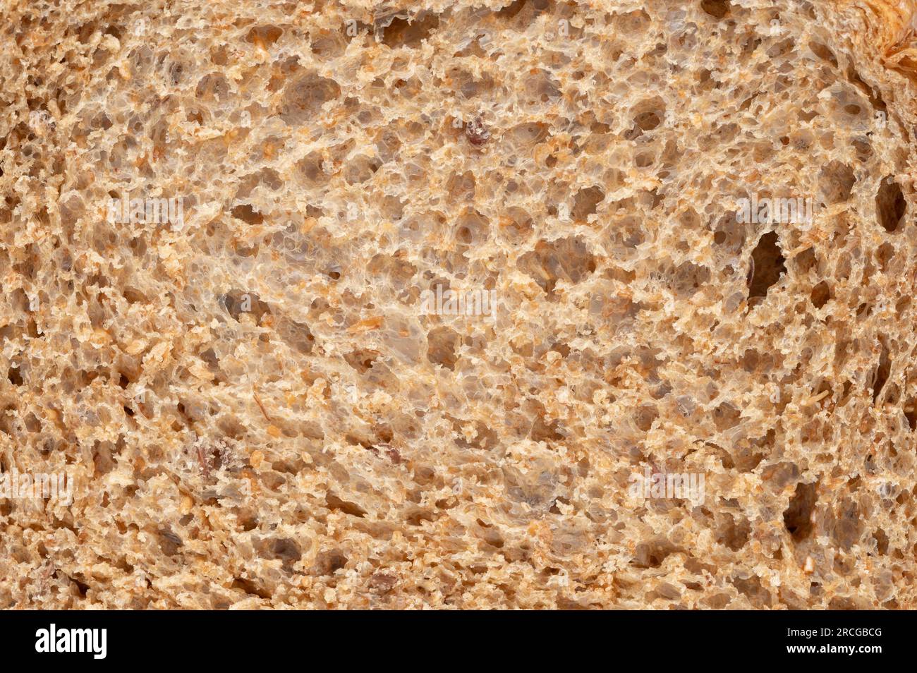 Pattern of brown bread texture with holes and seed macro close up view ...