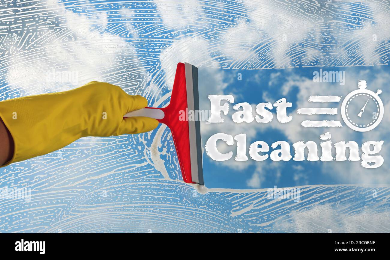Fast cleaning service. Worker wiping window with squeegee, closeup ...