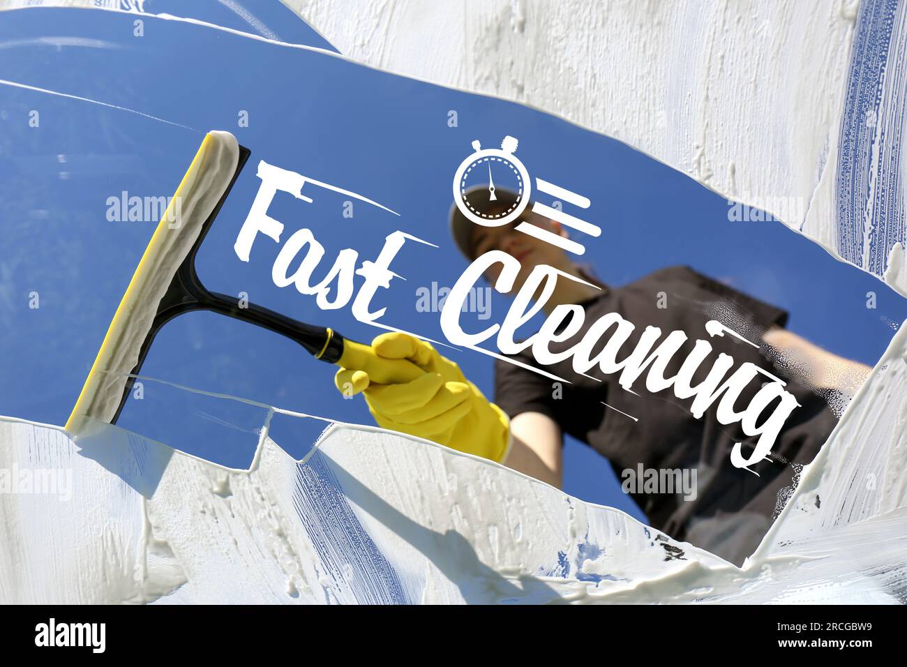 Fast cleaning service. Worker wiping window with squeegee outdoors ...