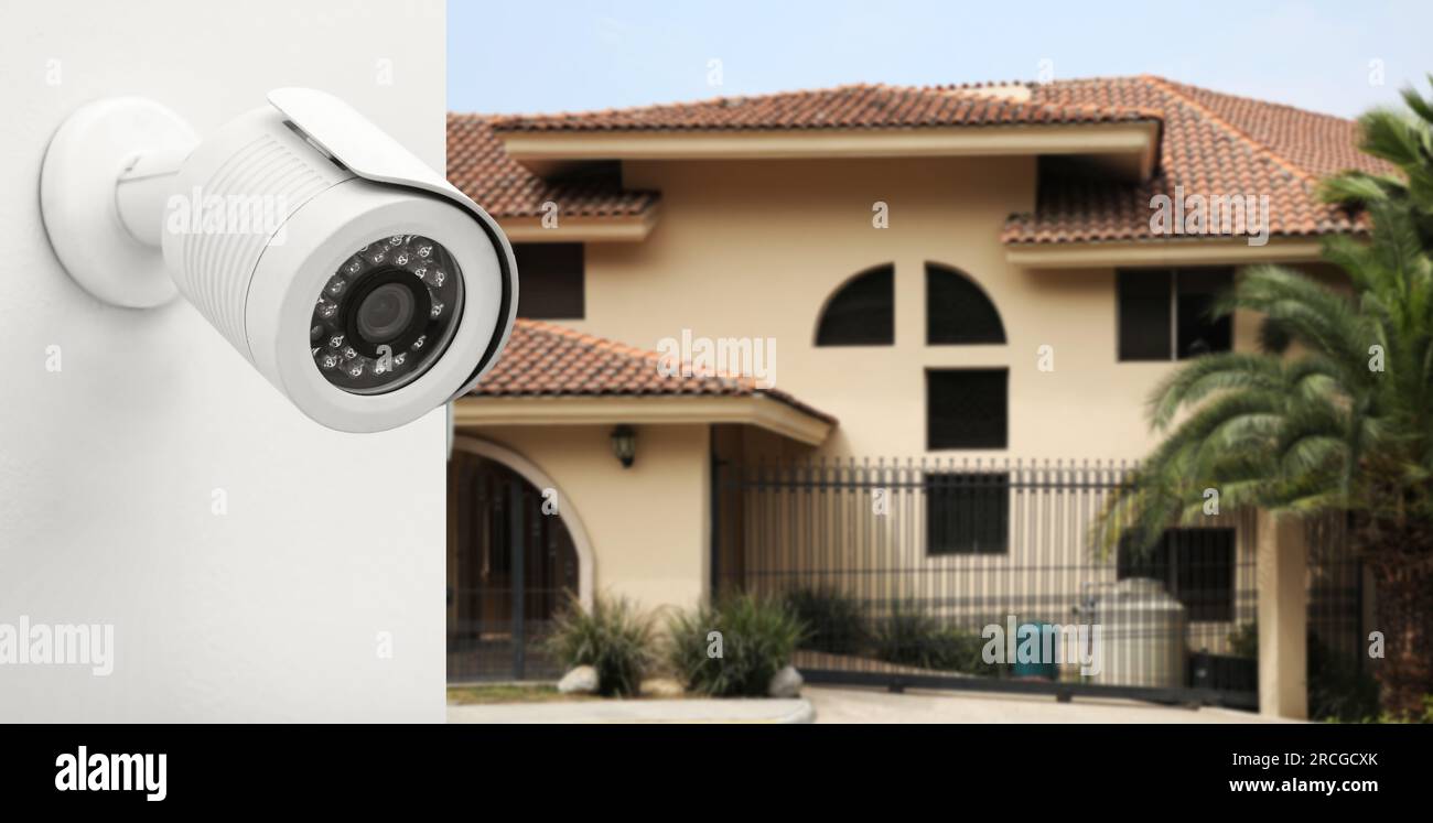 Home security camera on wall against house on street, closeup Stock ...
