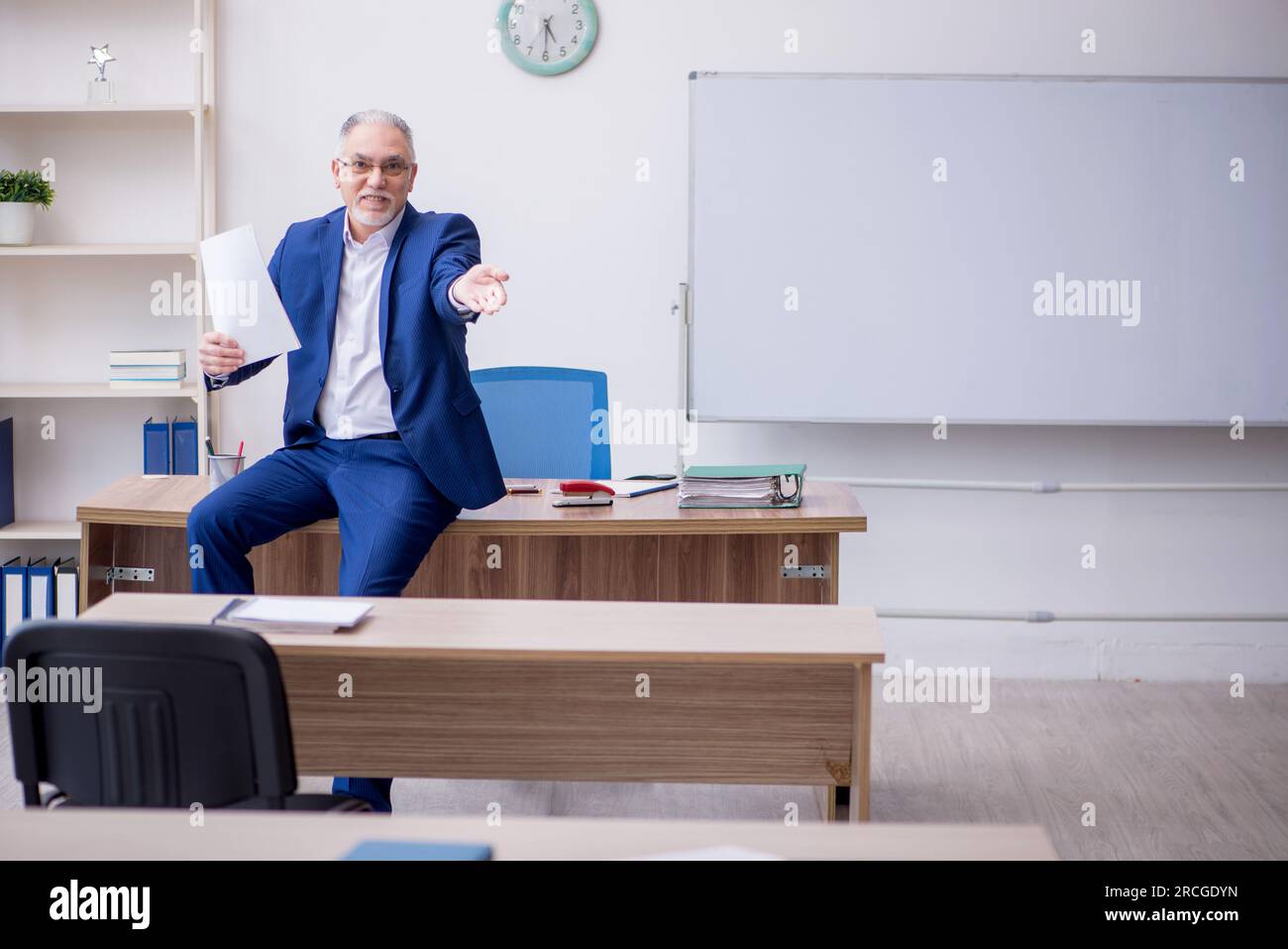 Old teacher in the classroom Stock Photo - Alamy
