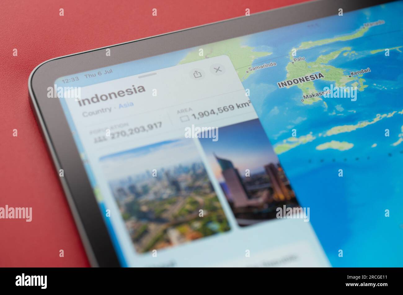 New York, USA - July 6, 2023: Indonesia country boarder on world apple map ipad close up view ...