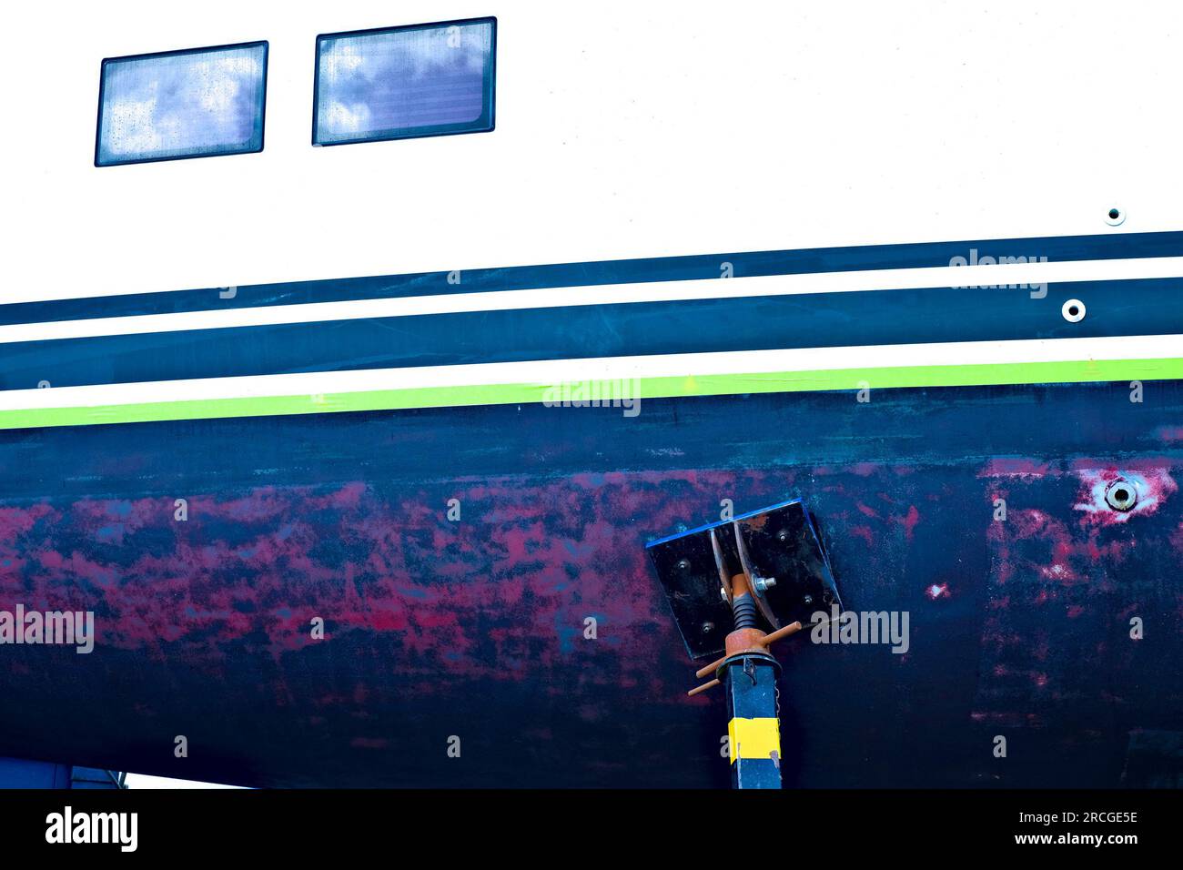 Modern sailing boat bottom supported with a stand, boatyard works on ...