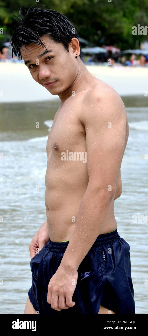 A handsome, young, shirtless, muscled, Asian man, aged in his twenties ...