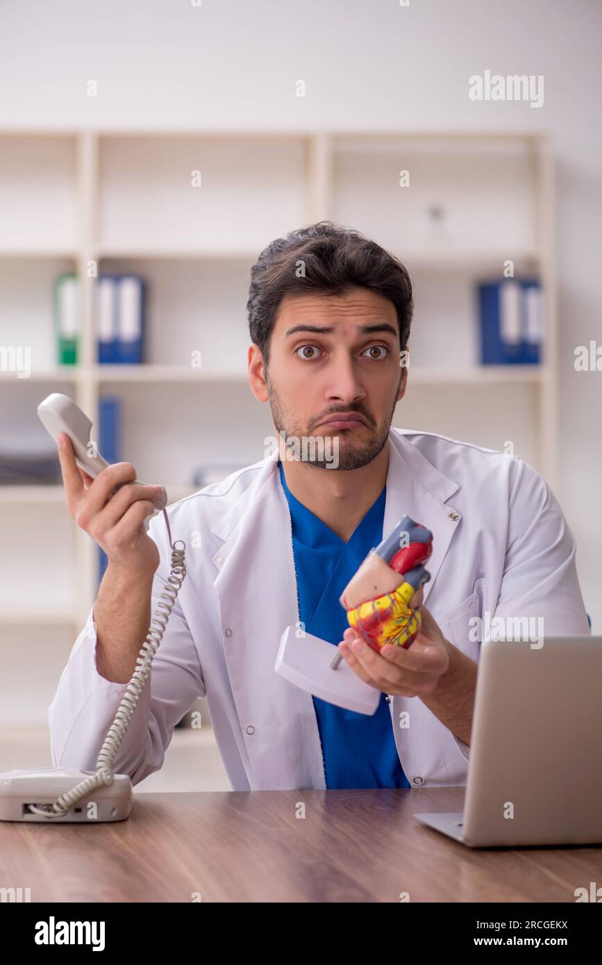 Young doctor cardiologist working at the hospital Stock Photo - Alamy