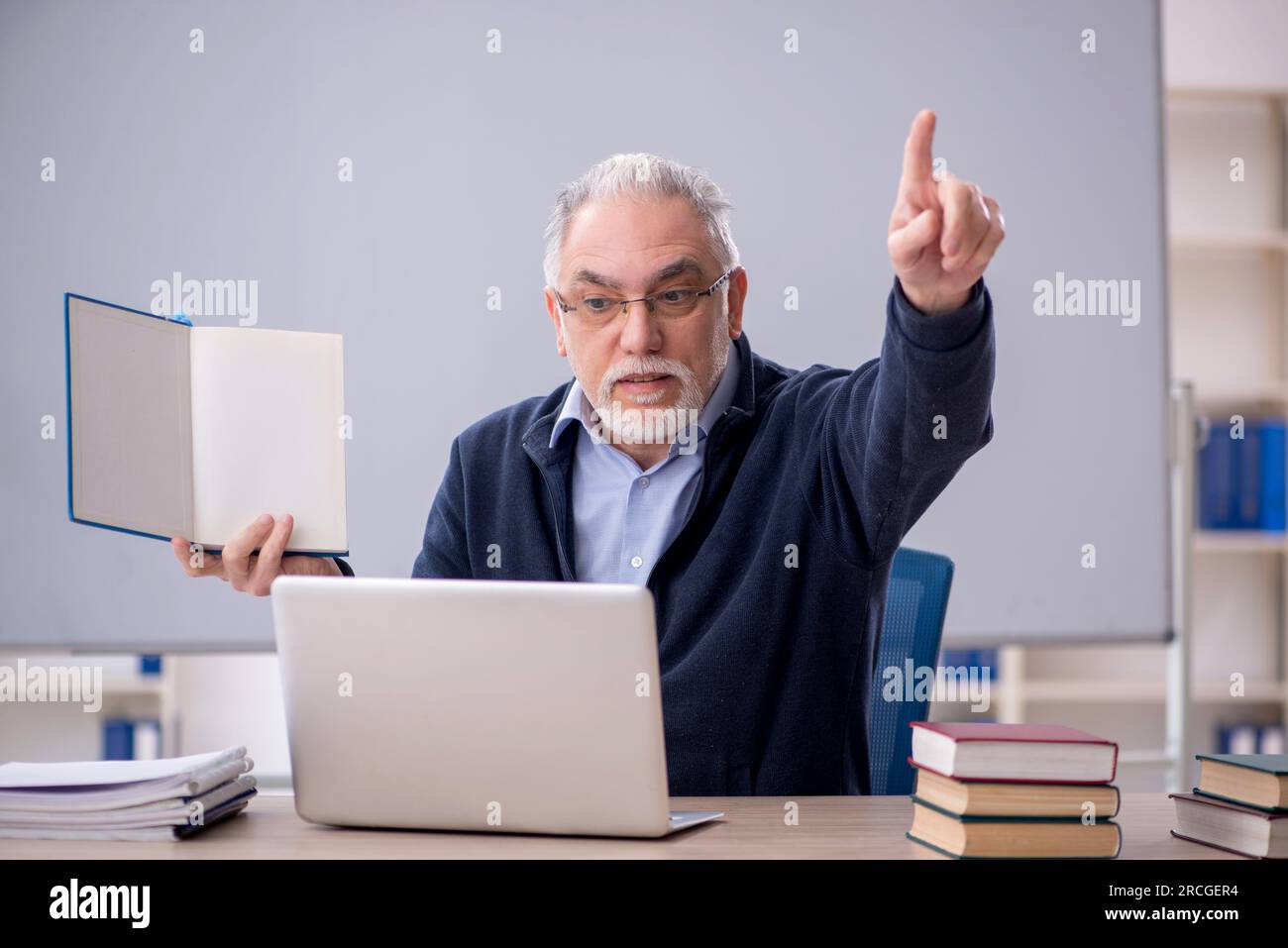 Old teacher in the classroom Stock Photo - Alamy