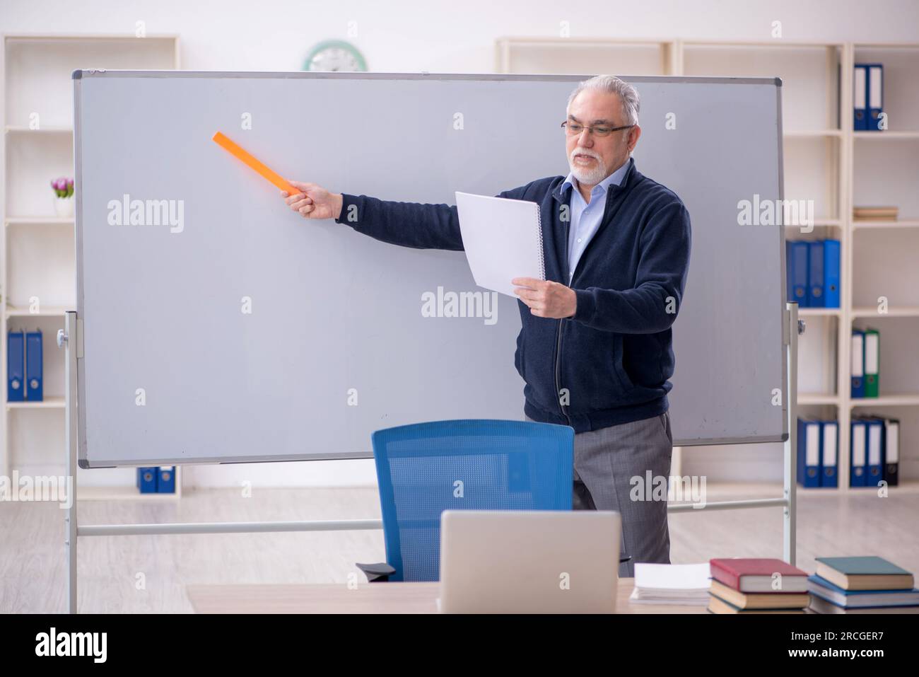Old teacher in the classroom Stock Photo - Alamy