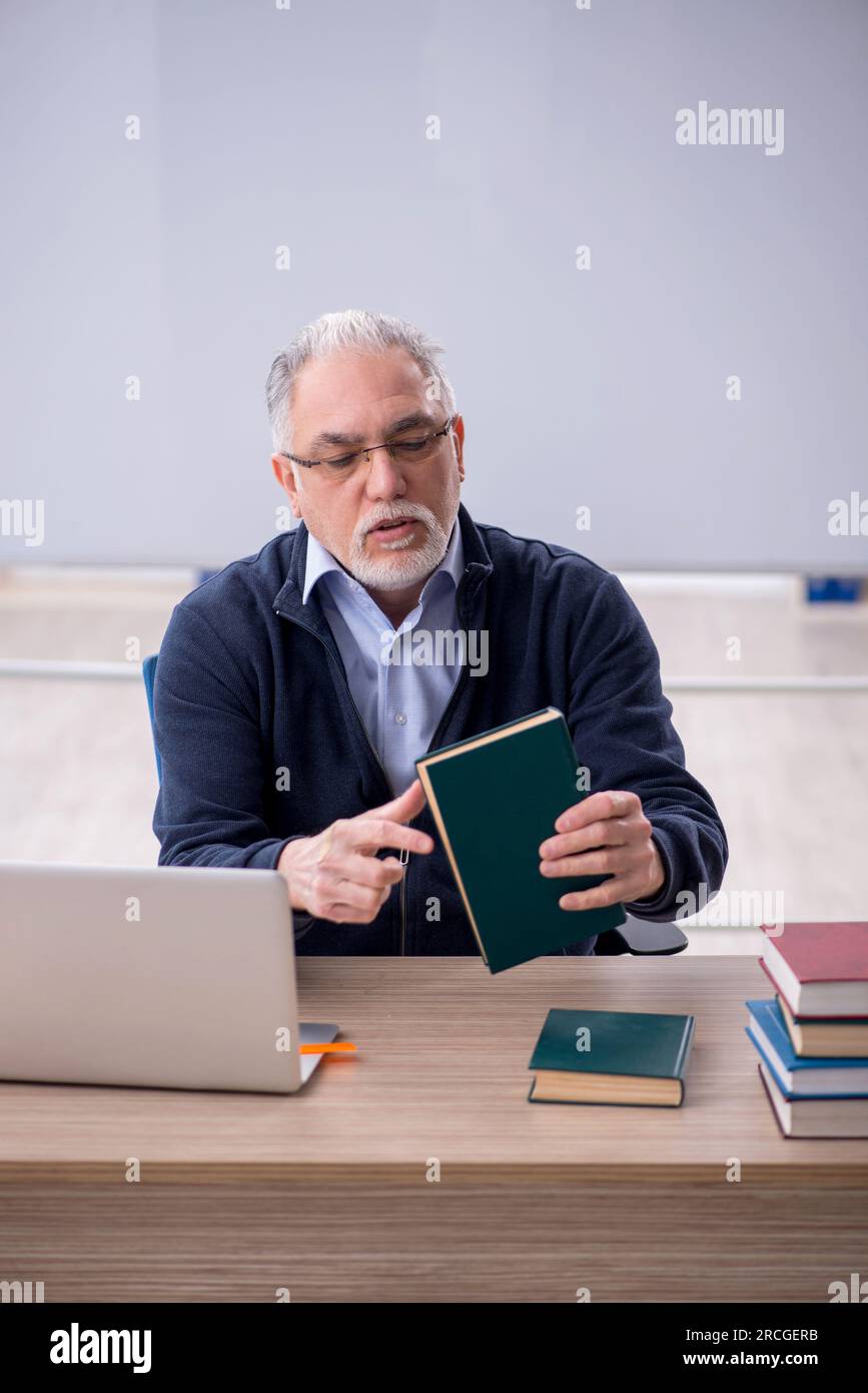 Old teacher in the classroom Stock Photo - Alamy