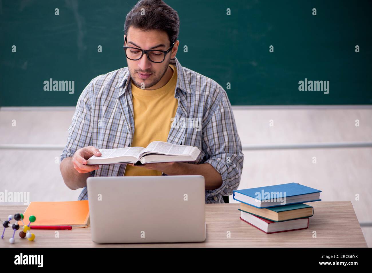 Young student sitting in the classroom Stock Photo - Alamy