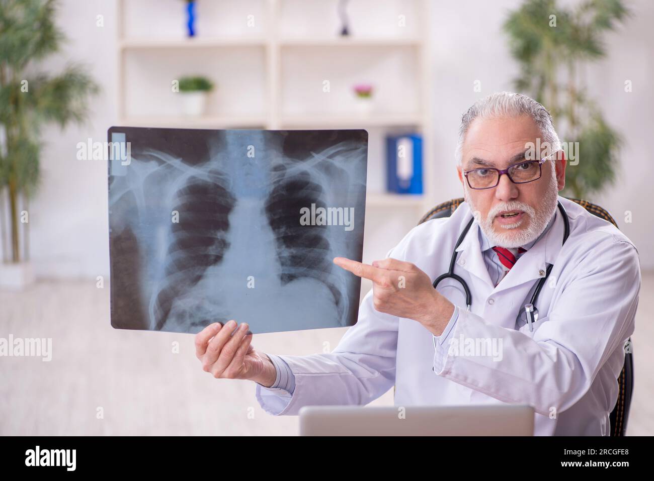 Old doctor radiologist working at the hospital Stock Photo - Alamy