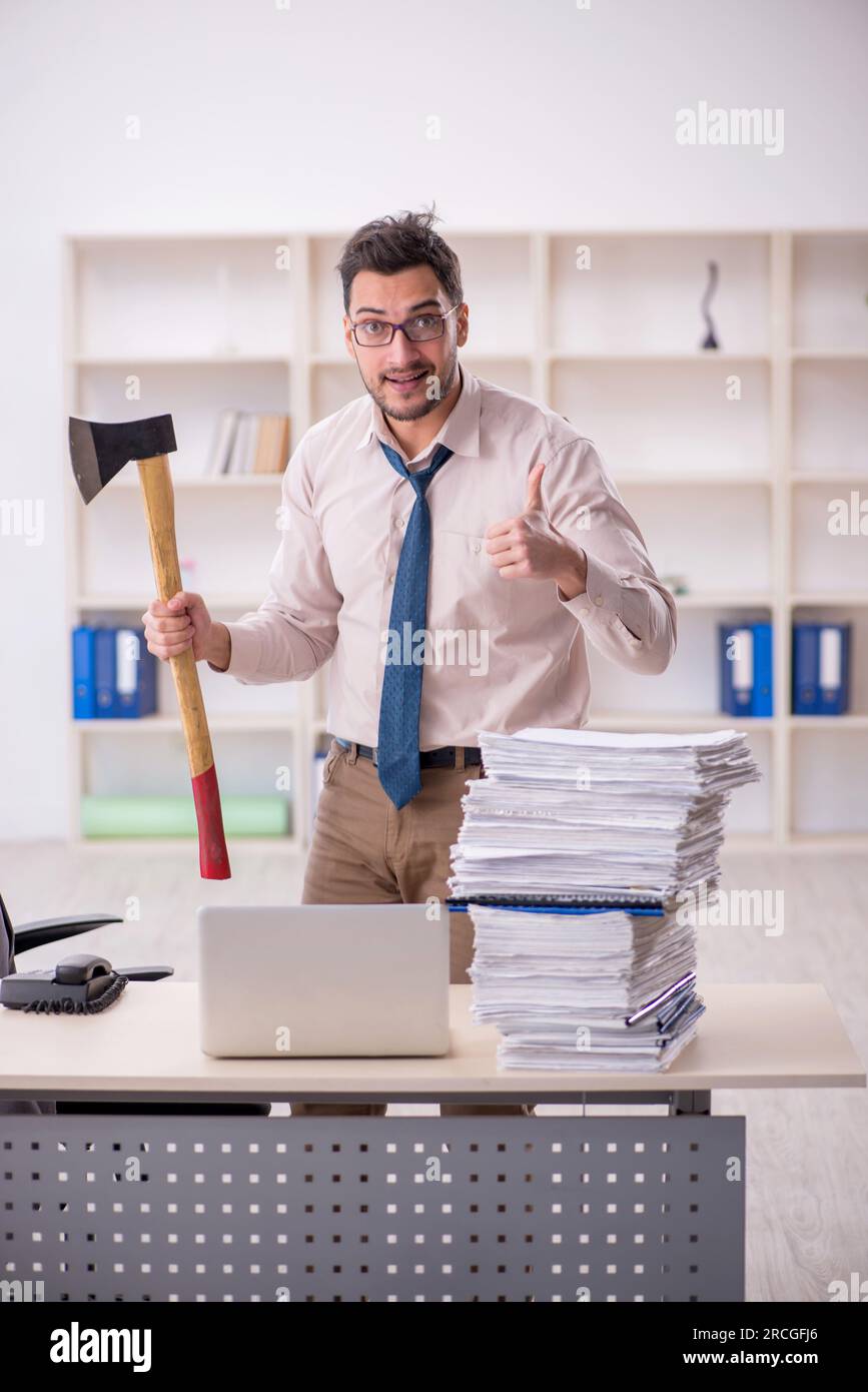 Young employee and too much work at workplace Stock Photo - Alamy