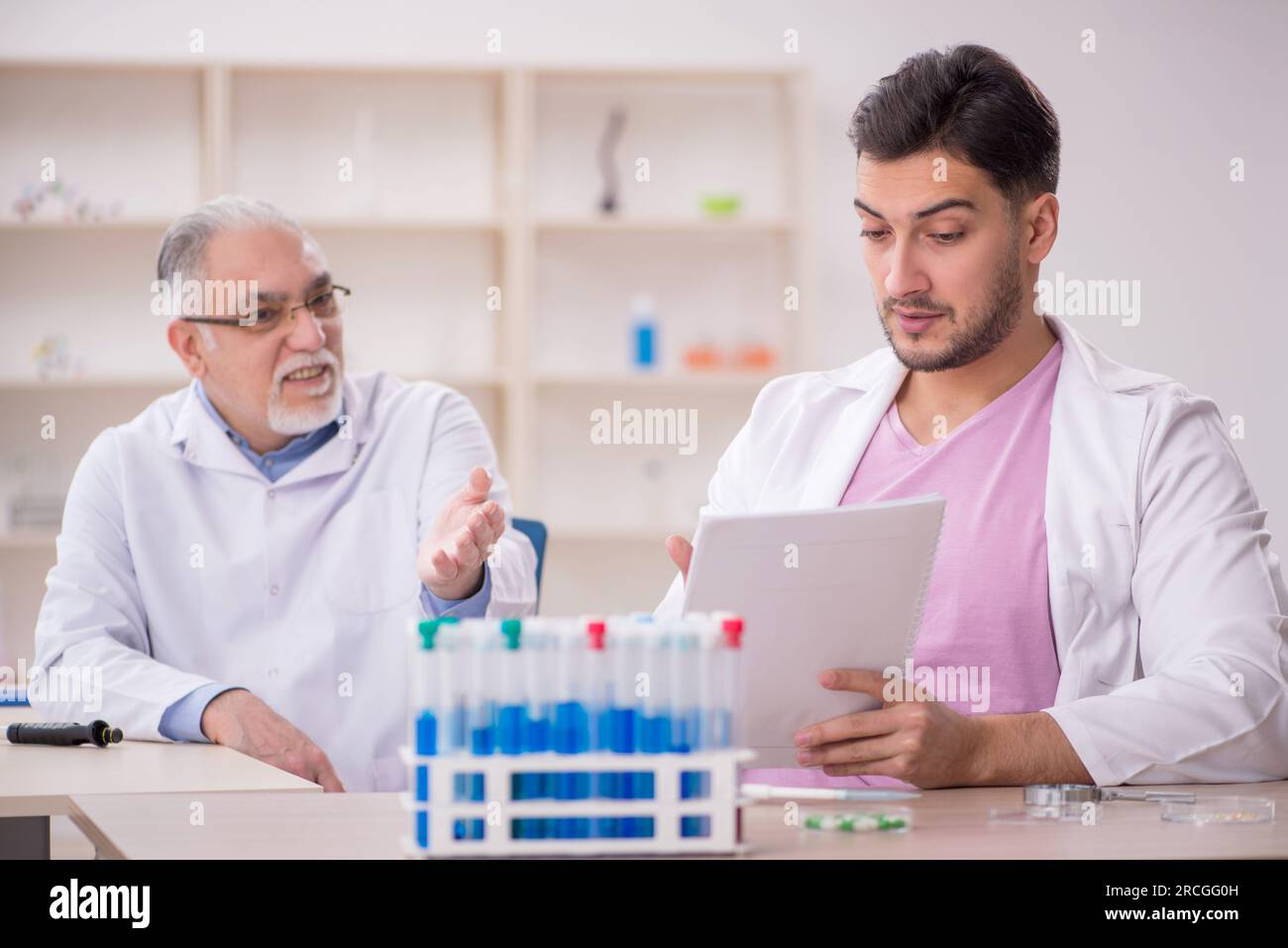 Two chemists working at the lab Stock Photo - Alamy