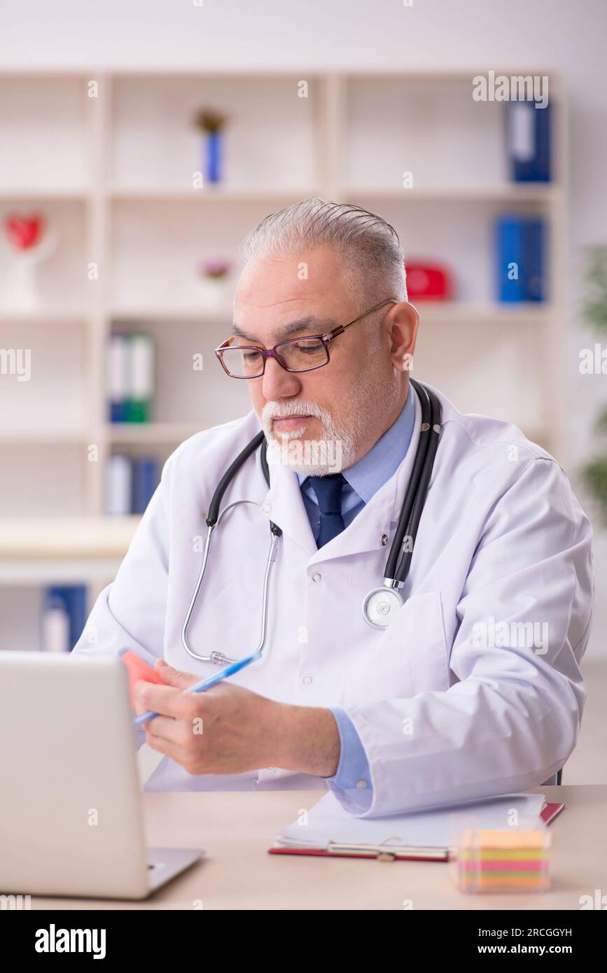 Old doctor working at the hospital Stock Photo - Alamy