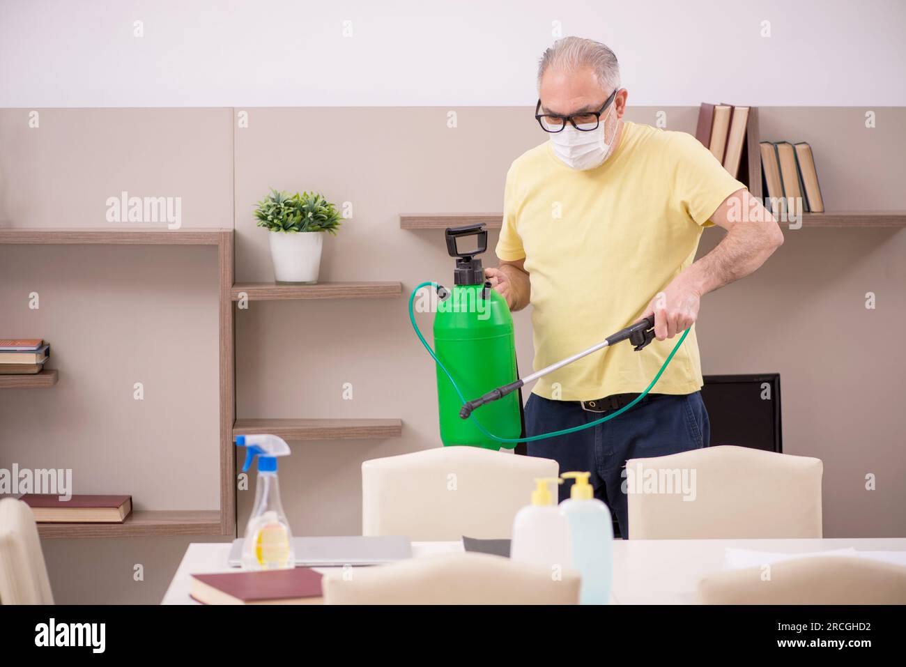 Old man cleaning the house Stock Photo - Alamy