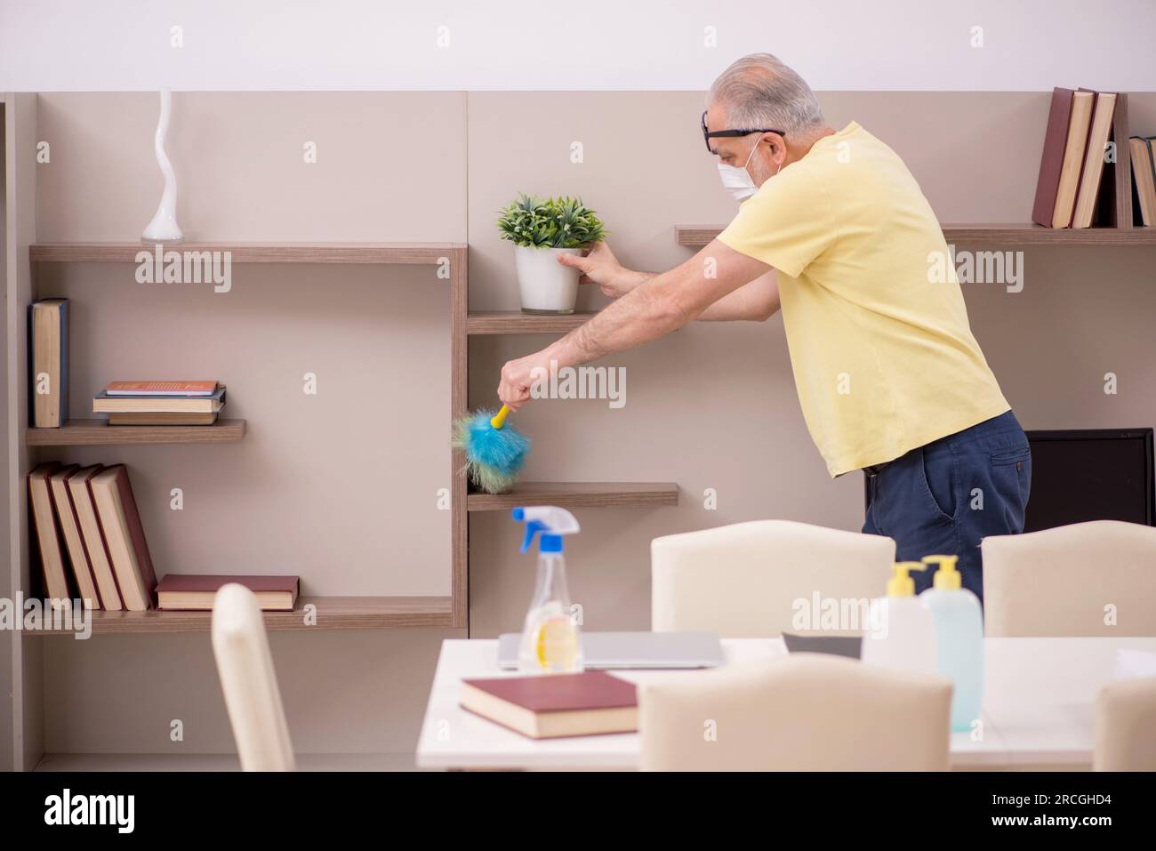 Old man cleaning the house Stock Photo - Alamy