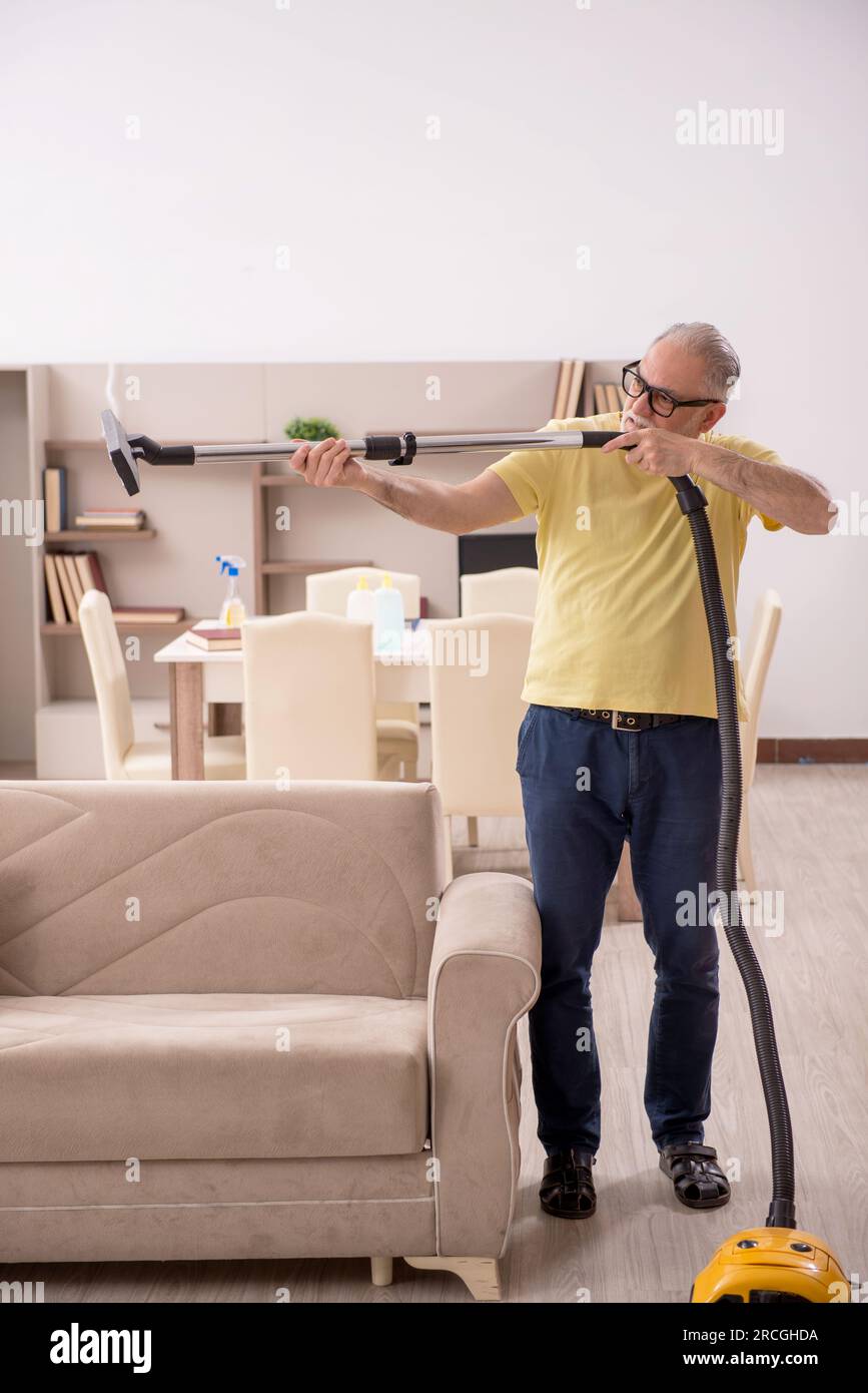 Old man cleaning the house Stock Photo - Alamy