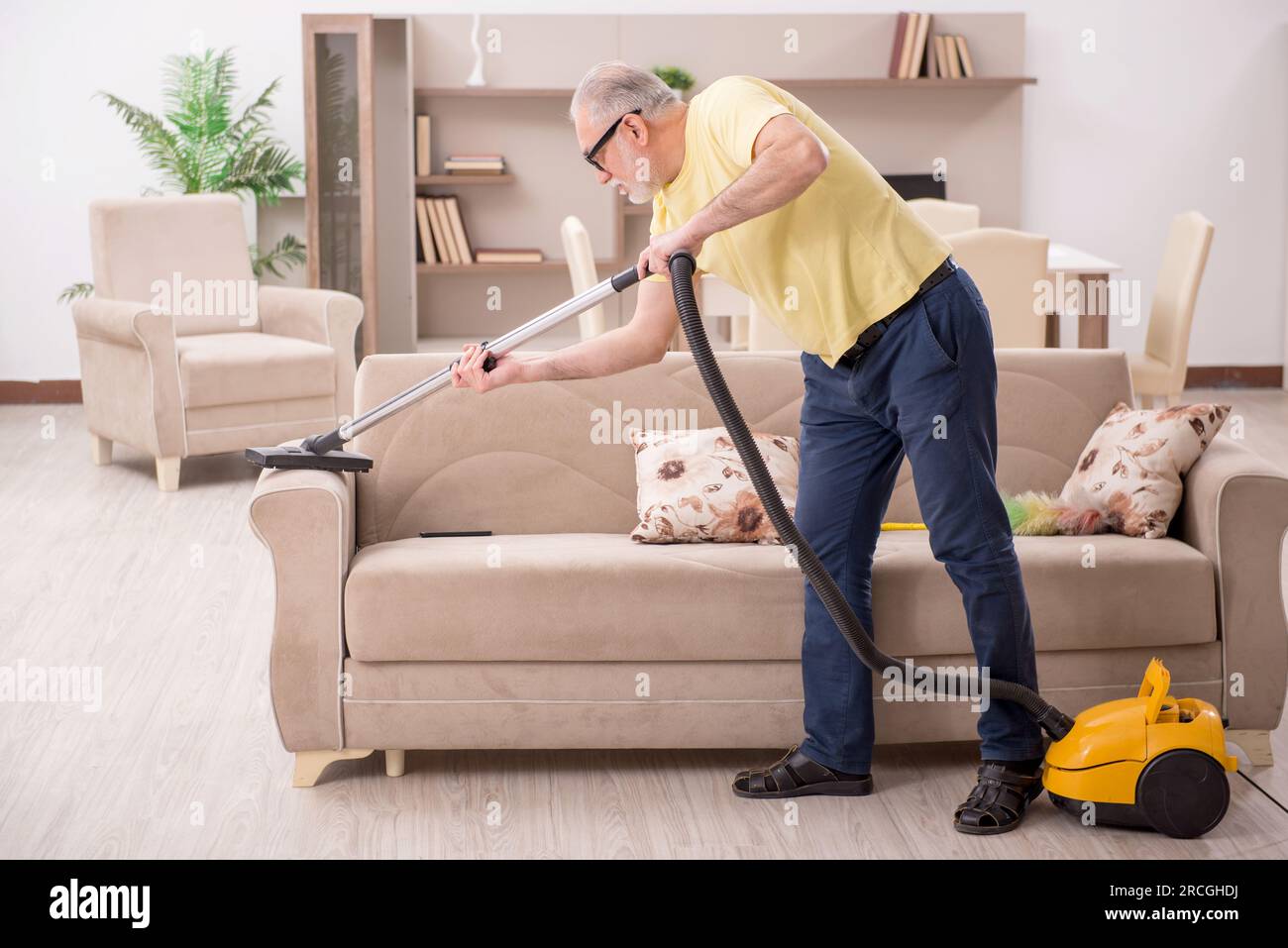 Old man cleaning the house Stock Photo - Alamy
