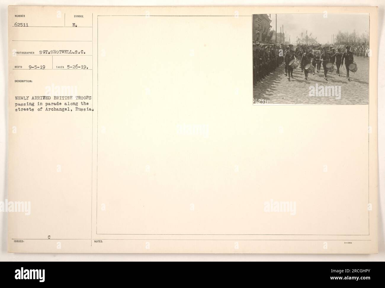 The photograph shows British troops parading along the streets of ...