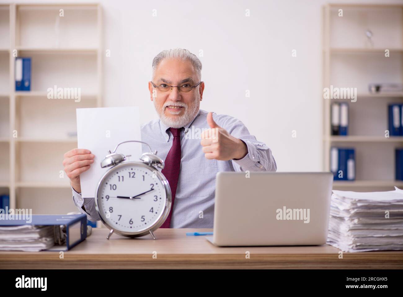 Old boss employee in time management concept Stock Photo - Alamy