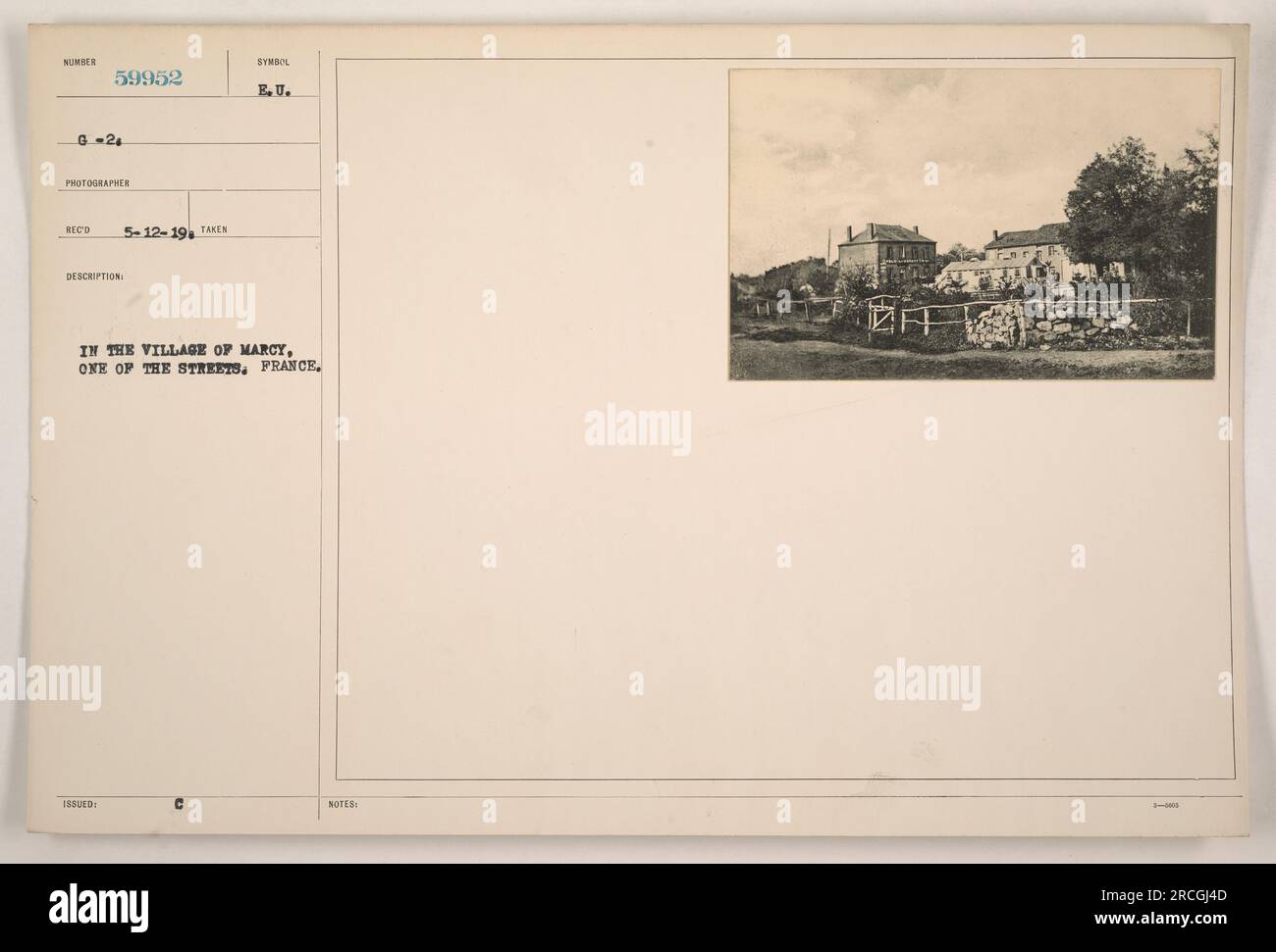 American soldiers patrolling a street in the village of Marcy, France ...