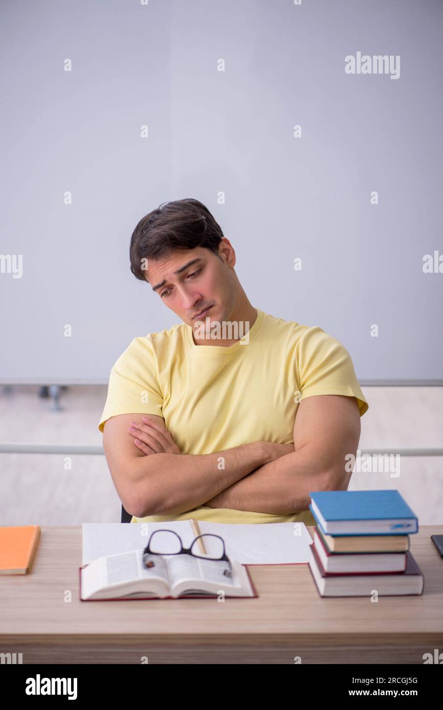 Young student sitting in the classroom Stock Photo - Alamy