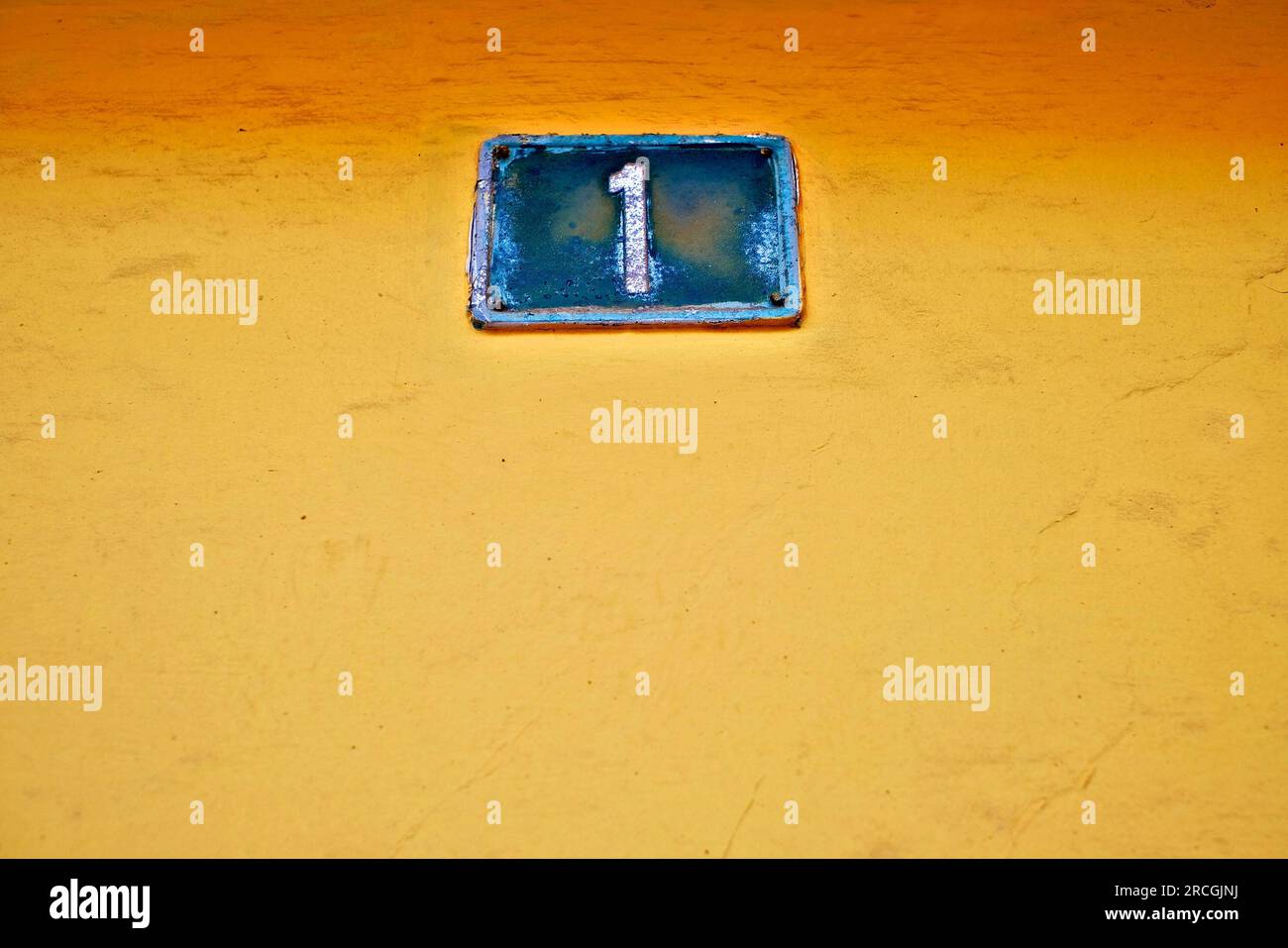 Blue plate number 6, six, on a saturated orange wall surface Stock ...