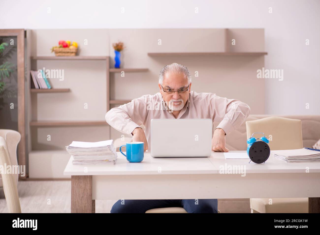 Old boss employee working from home during pandemic Stock Photo - Alamy