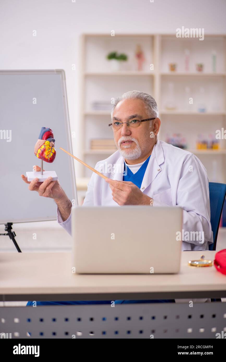 Old doctor cardiologist working at the hospital Stock Photo - Alamy