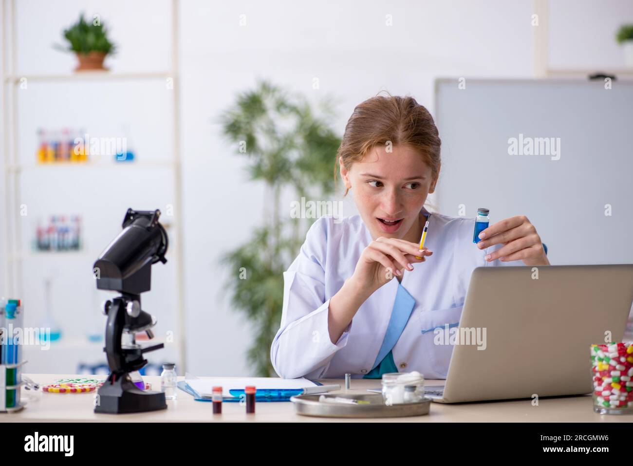 Young girl chemist in drugs synthesis concept Stock Photo - Alamy