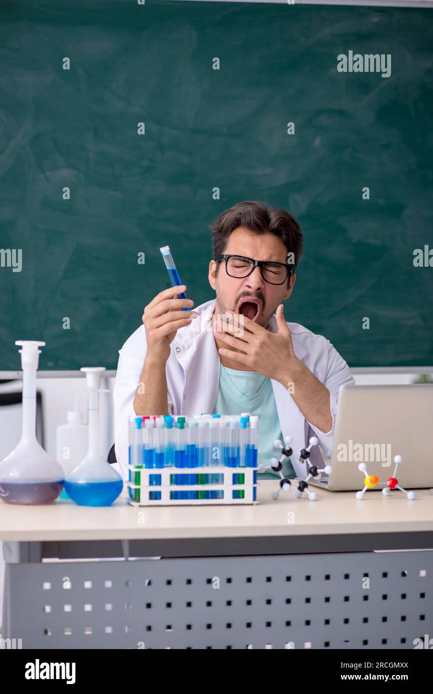 Young chemist in front of blackboard Stock Photo - Alamy
