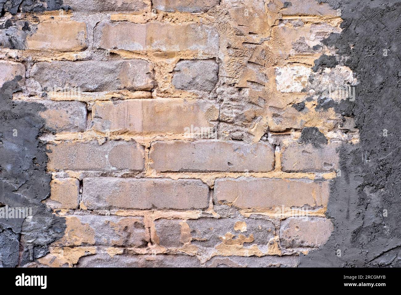 Vintage weathered brick and mortar wall will patches of wethered ...