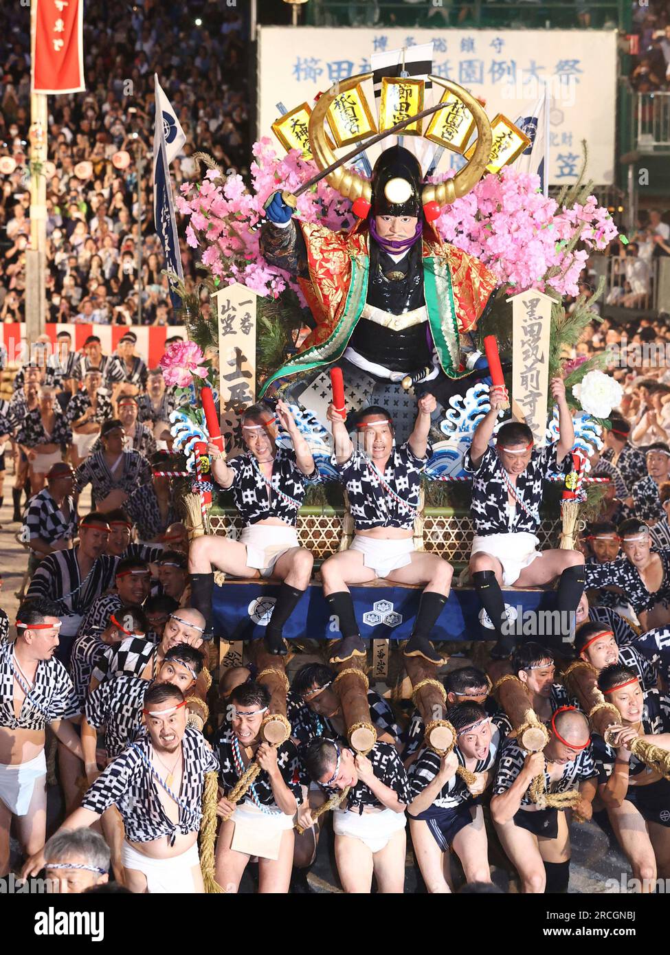 A Yamakasa float rushes for Kushida Jinja Shrine during Hakata Gion ...