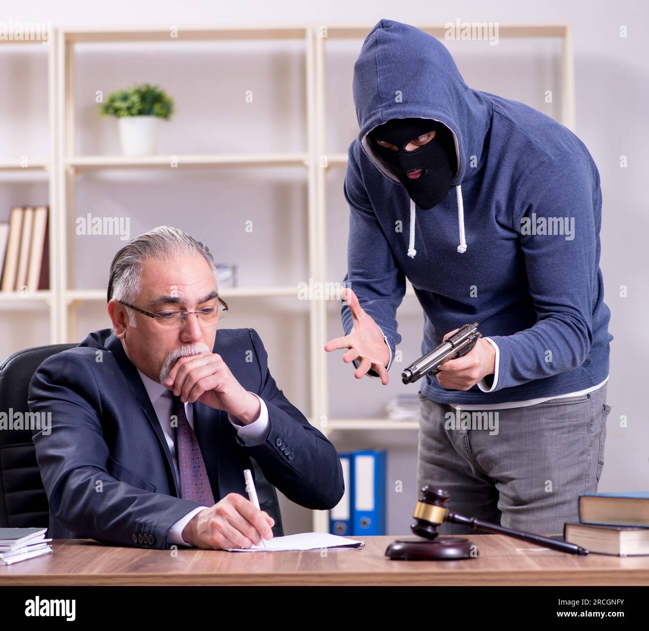 The young mobster threatening old judge Stock Photo - Alamy