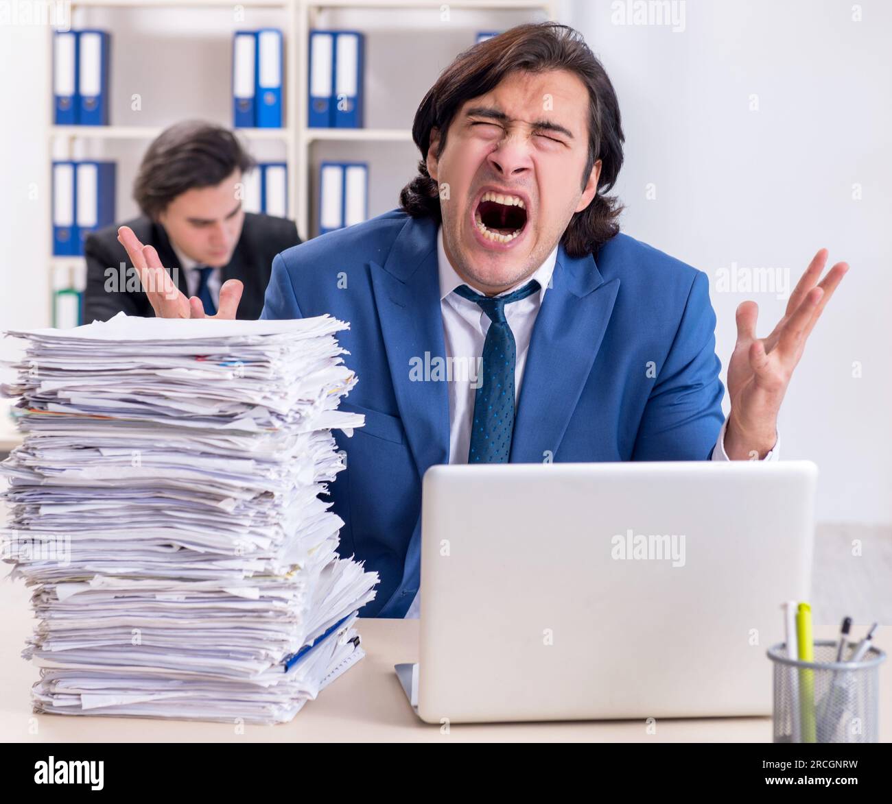 The two male colleagues unhappy with excessive work Stock Photo - Alamy