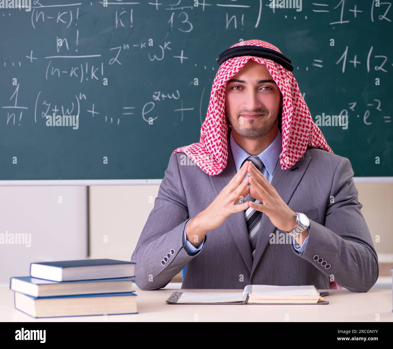 The arab teacher wearing suit in front of chalkboard Stock Photo - Alamy