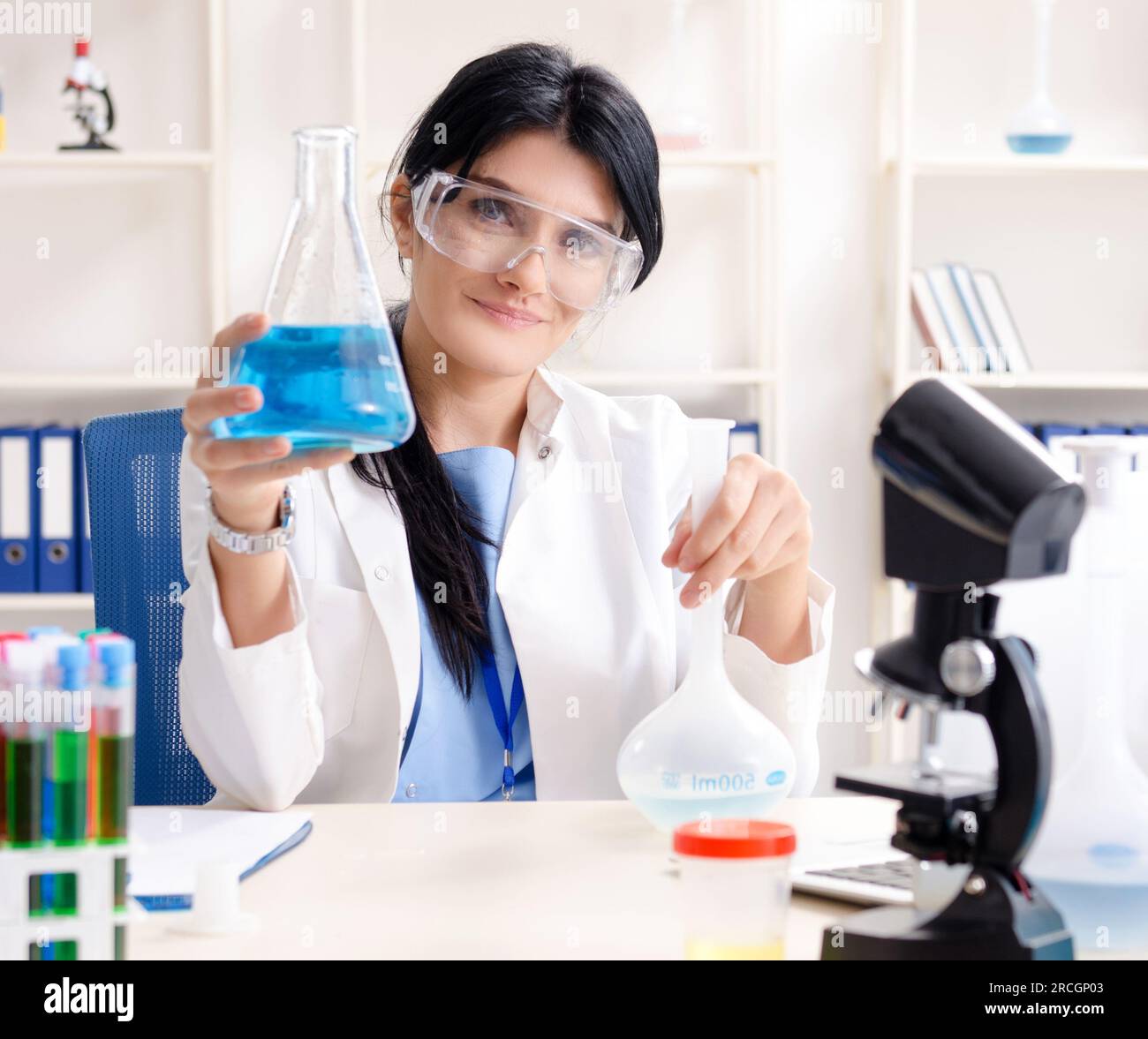 Female scientist mixing chemical solution hi-res stock photography and ...
