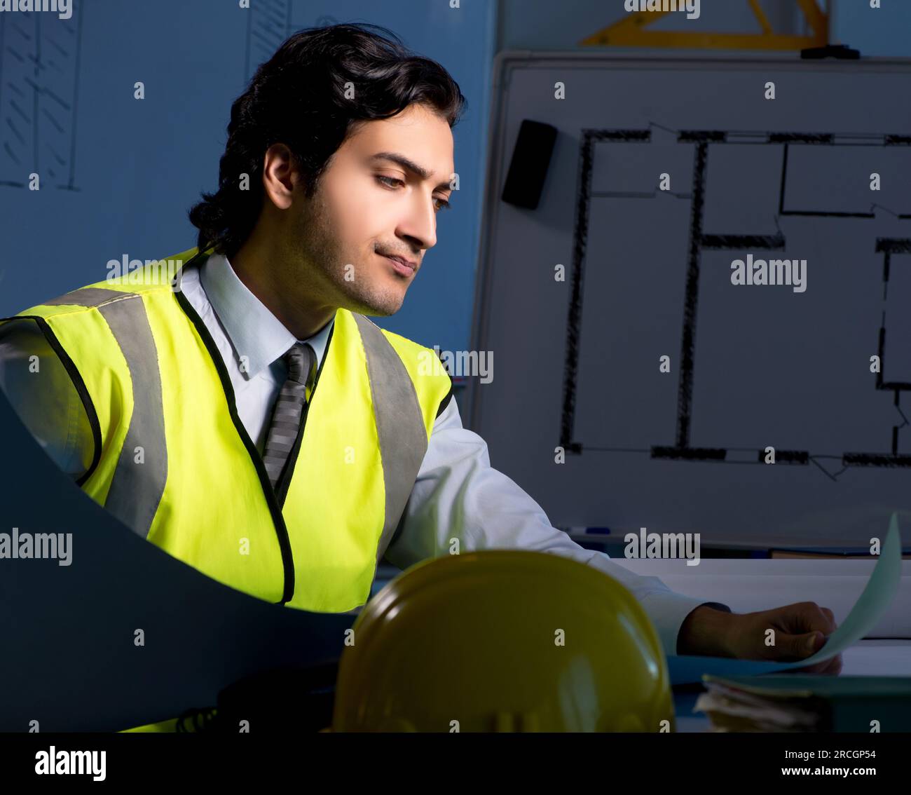 The young construction architect working on project at night Stock ...