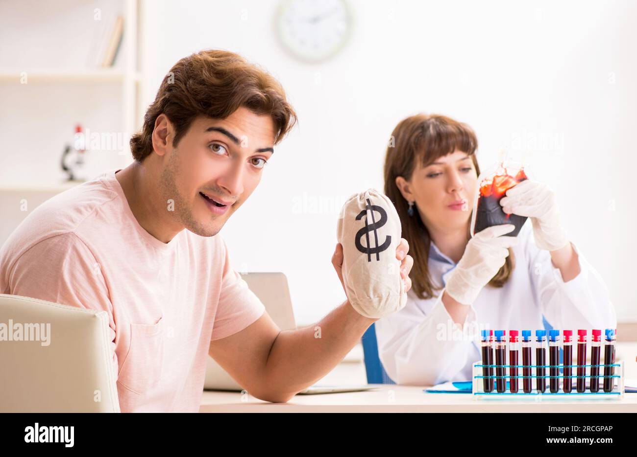 The man giving his blood as a donor Stock Photo - Alamy